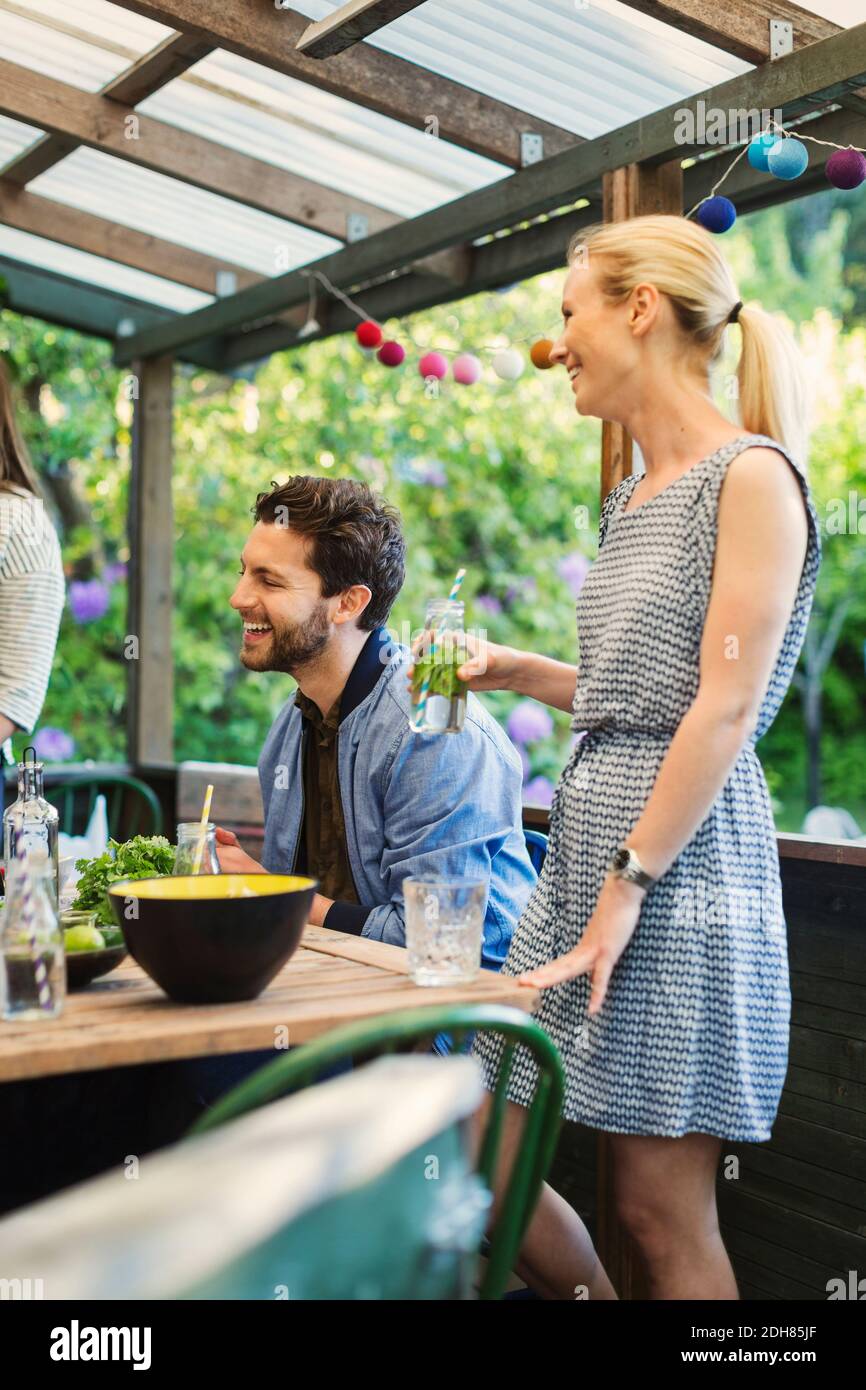 Happy friends enjoying summer party in log cabin Stock Photo - Alamy