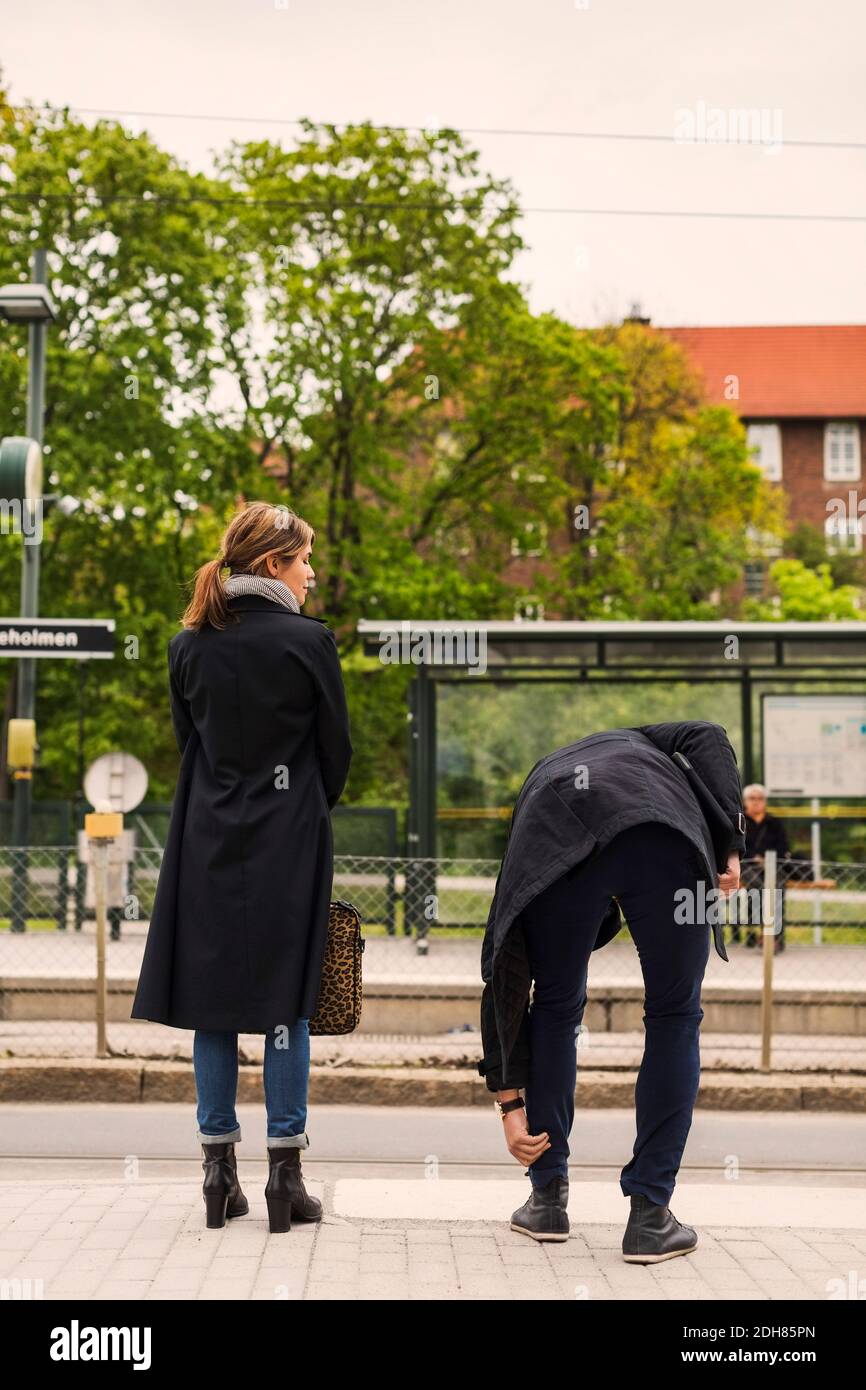 Rear view of male and female passengers on platform Stock Photo - Alamy