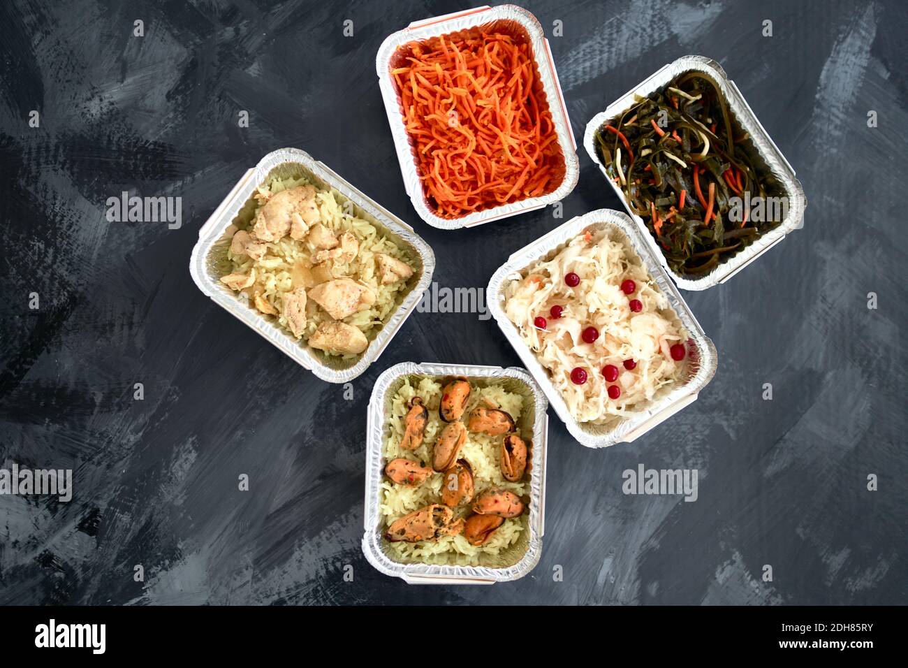 Different foil containers with delicious food. Delivery service Stock ...