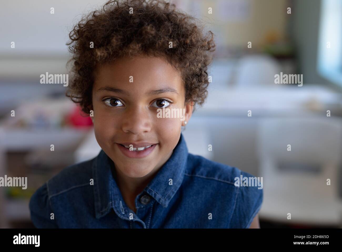 Schoolgirl looking to camera in an elementary school classroom Stock ...