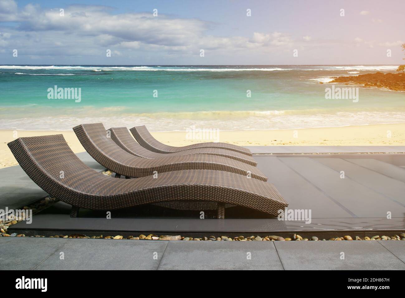 Lounging Sunbeds by the Swimming Pool with Seascape Background Stock ...