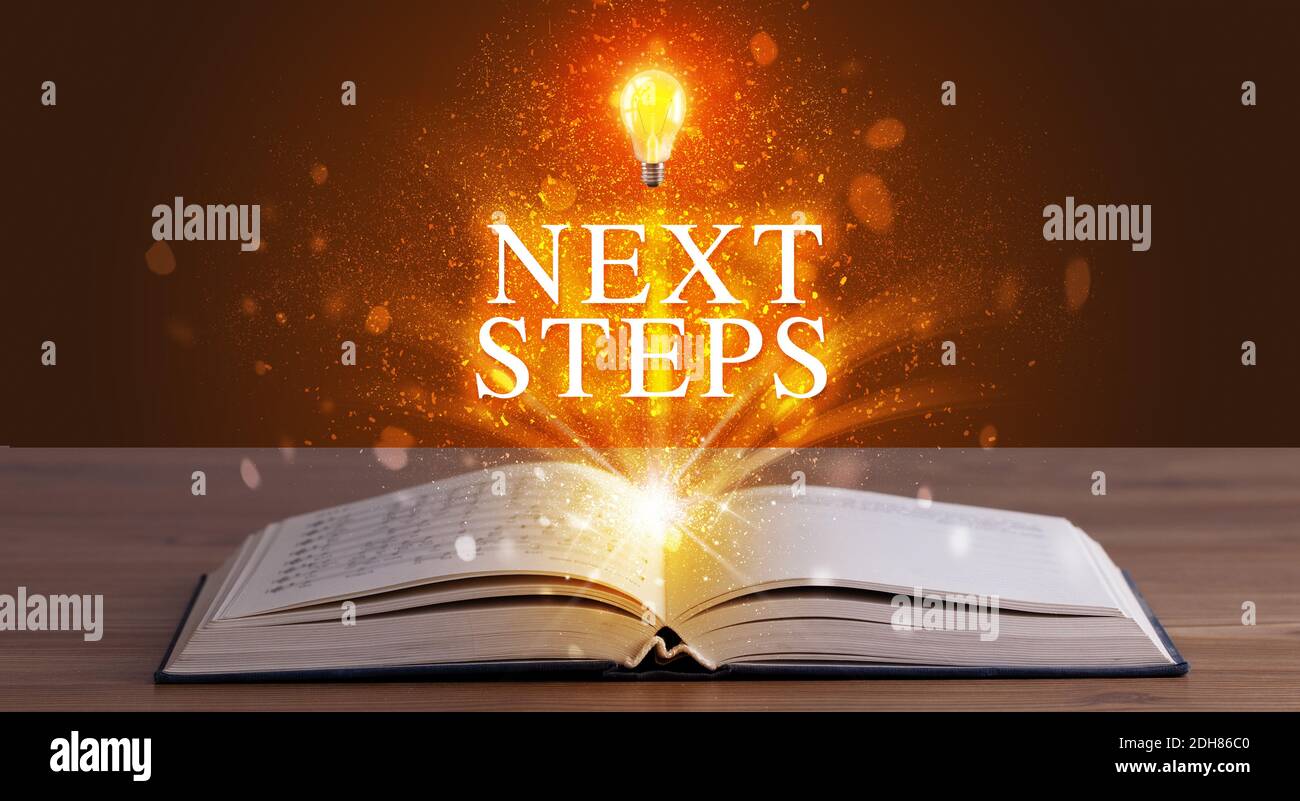 NEXT STEPS inscription coming out from an open book, educational ...