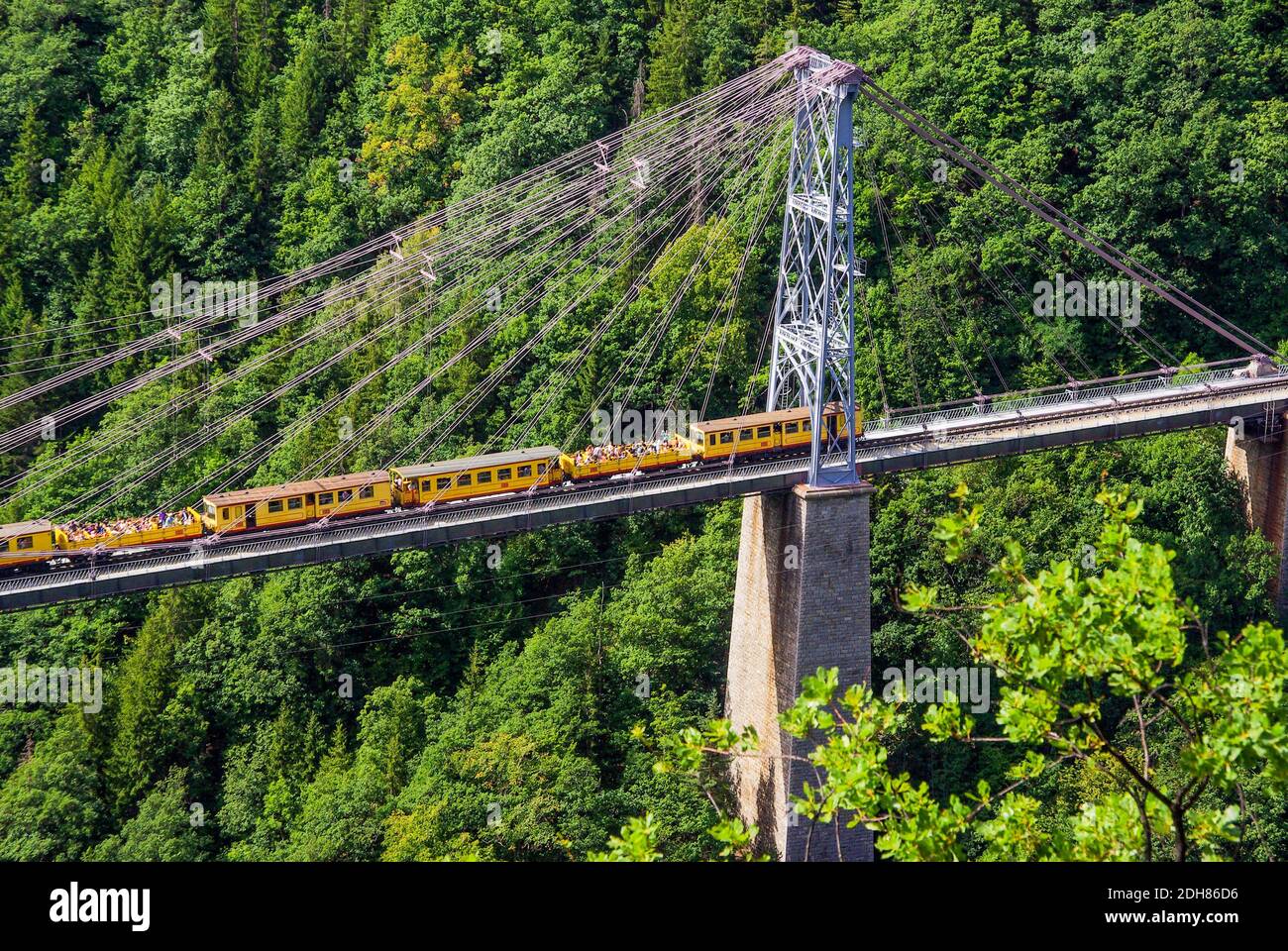 A bird's-eye view of a train on a railway bridge in the French Pyrenees ...