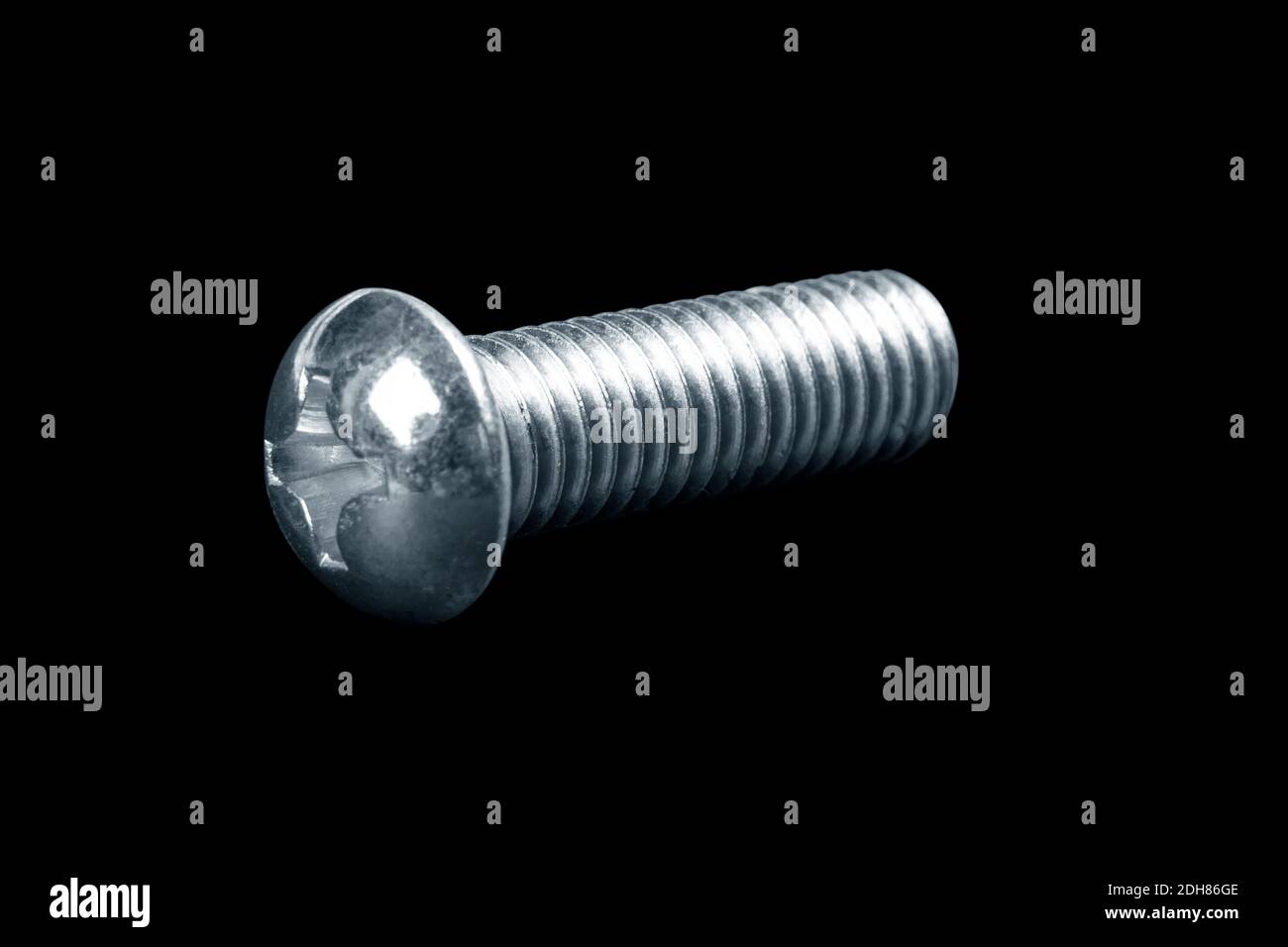 Macro shot metal bolt isolated on black background. Chromed screw bolt ...