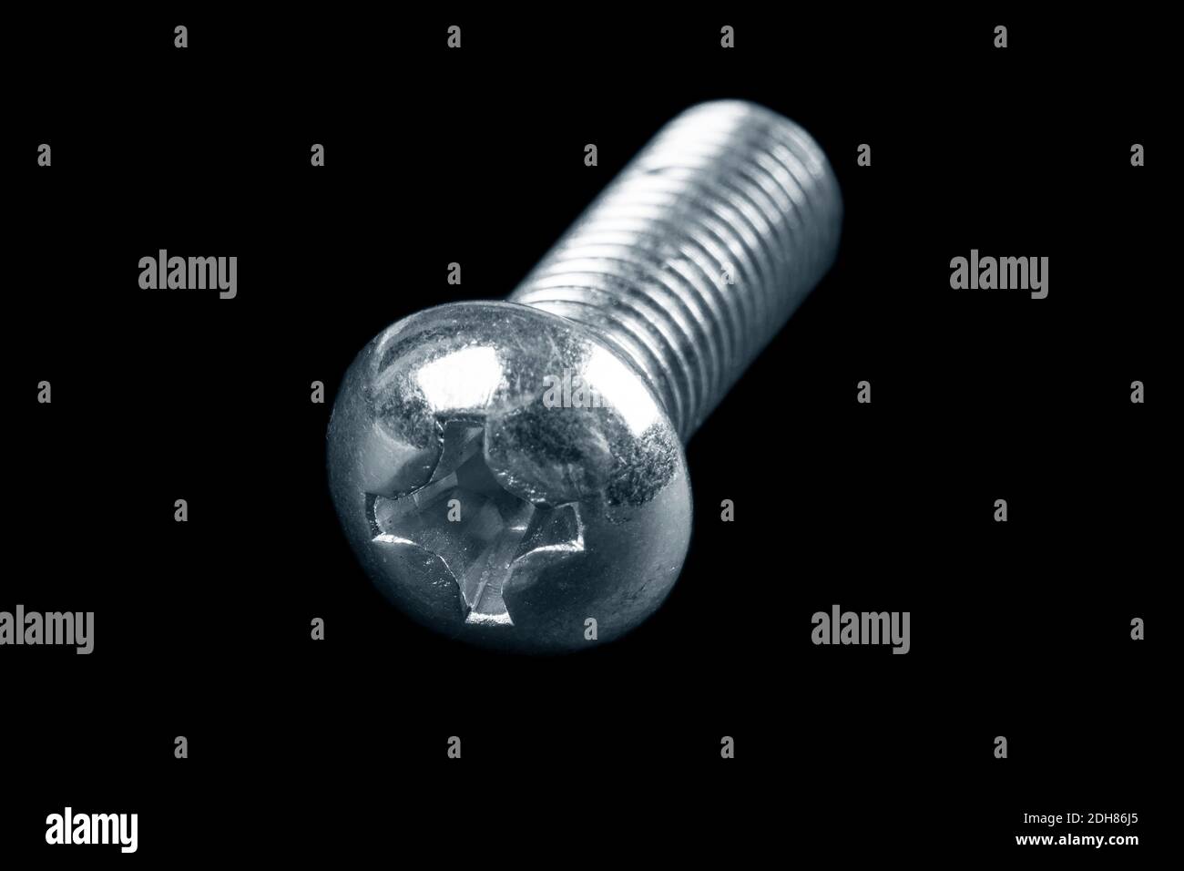 Macro shot metal bolt isolated on black background. Chromed screw bolt ...