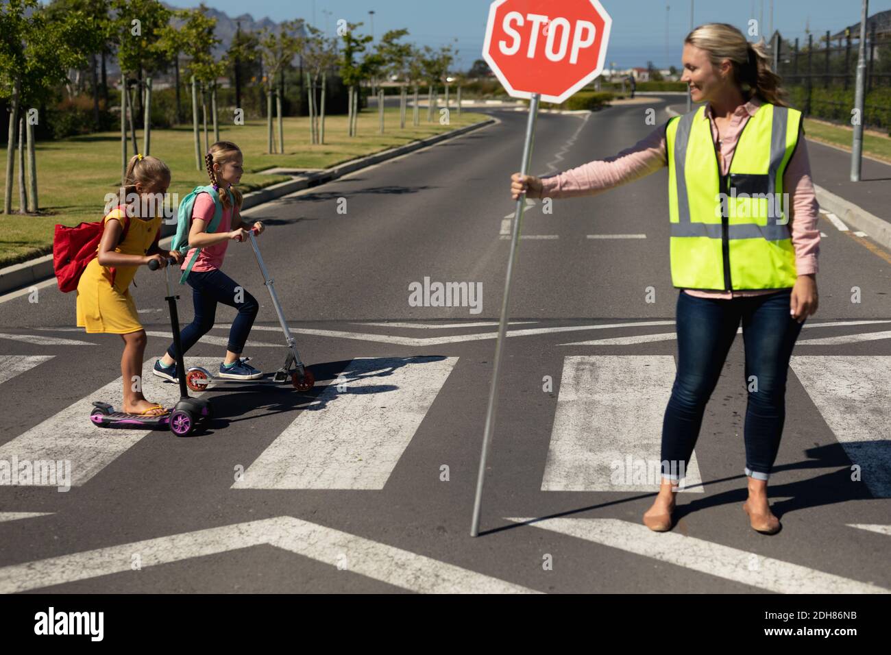 Woman wearing a high visibility vest and holding a stop sign Stock ...