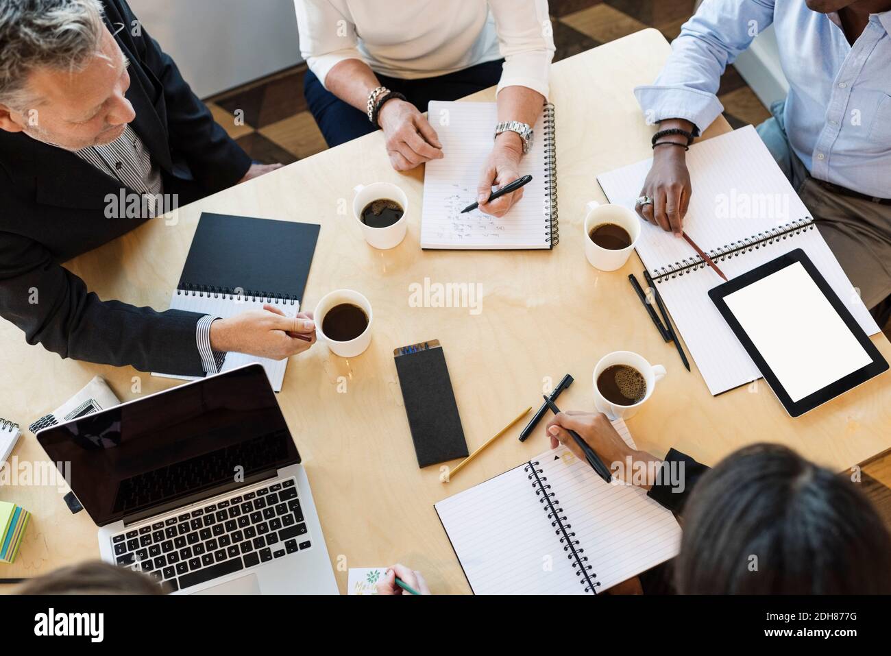 High angle view of business people discussing on table in office Stock ...