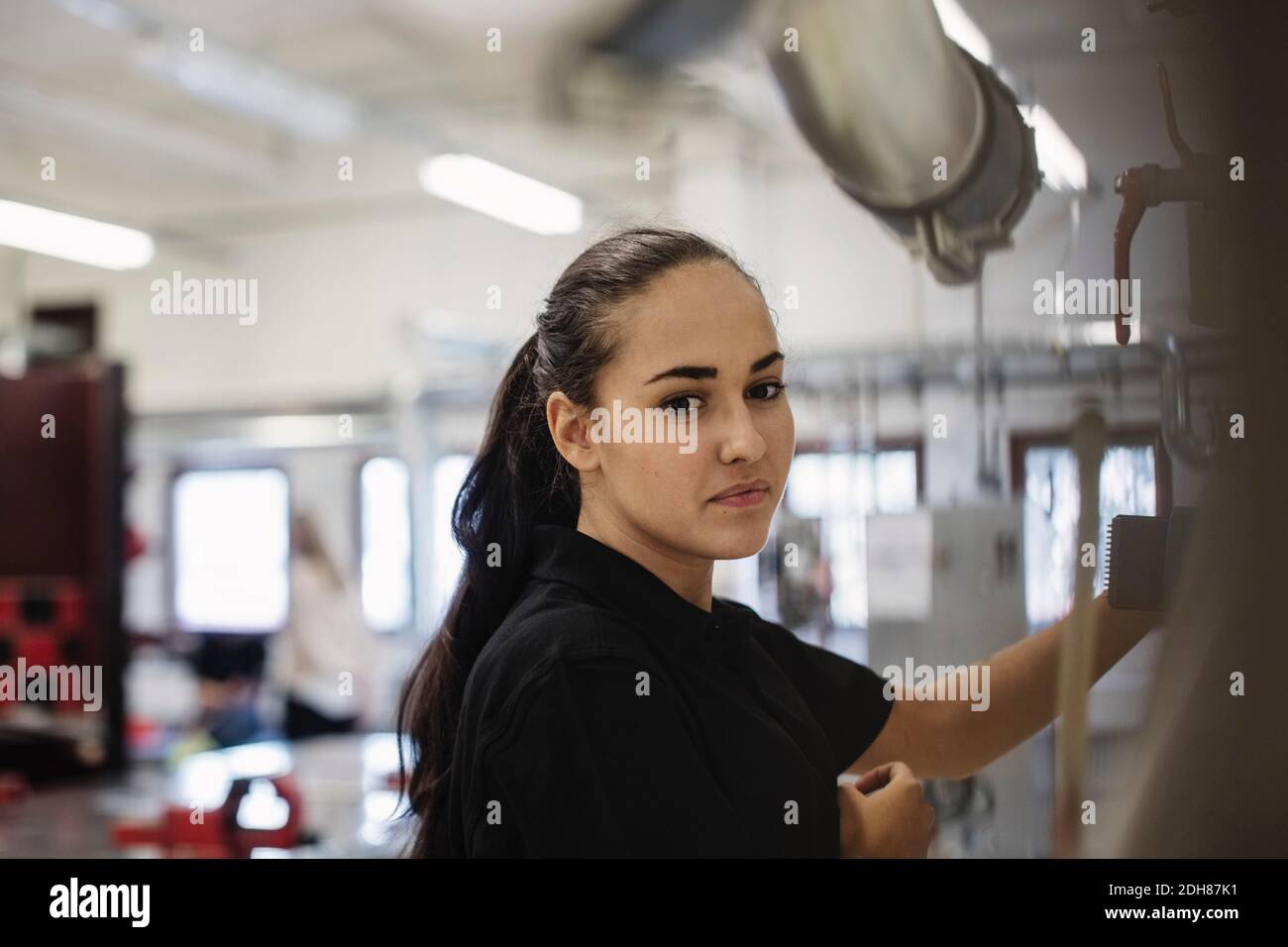Side view portrait of auto mechanic student at workshop Stock Photo - Alamy