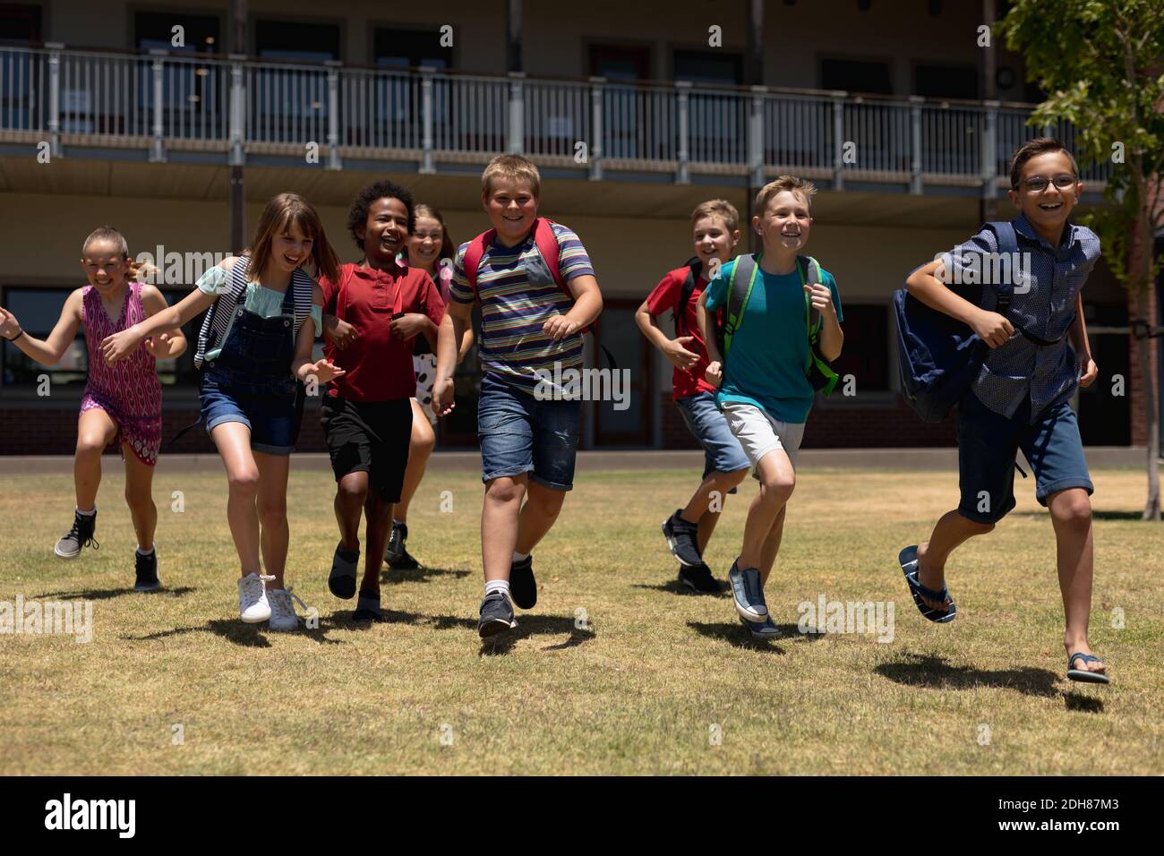 Group of schoolchildren running in a playing at elementary school Stock ...