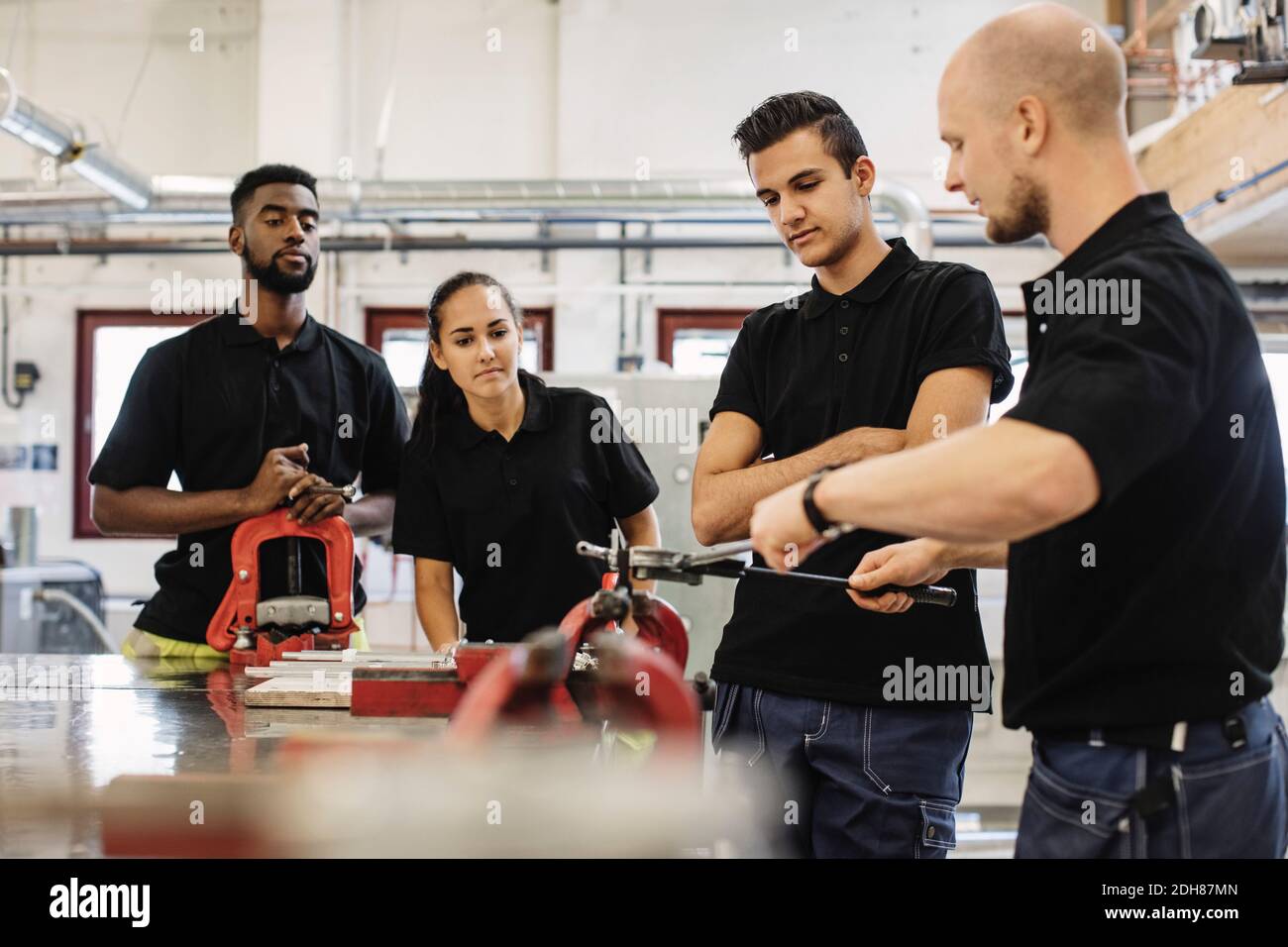 Auto mechanic teacher explaining equipment to students in class Stock ...