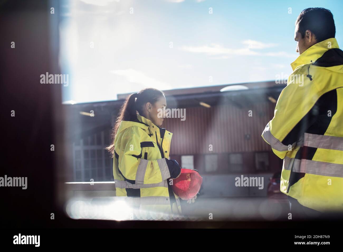 Male and female auto mechanic students seen through glass window Stock ...