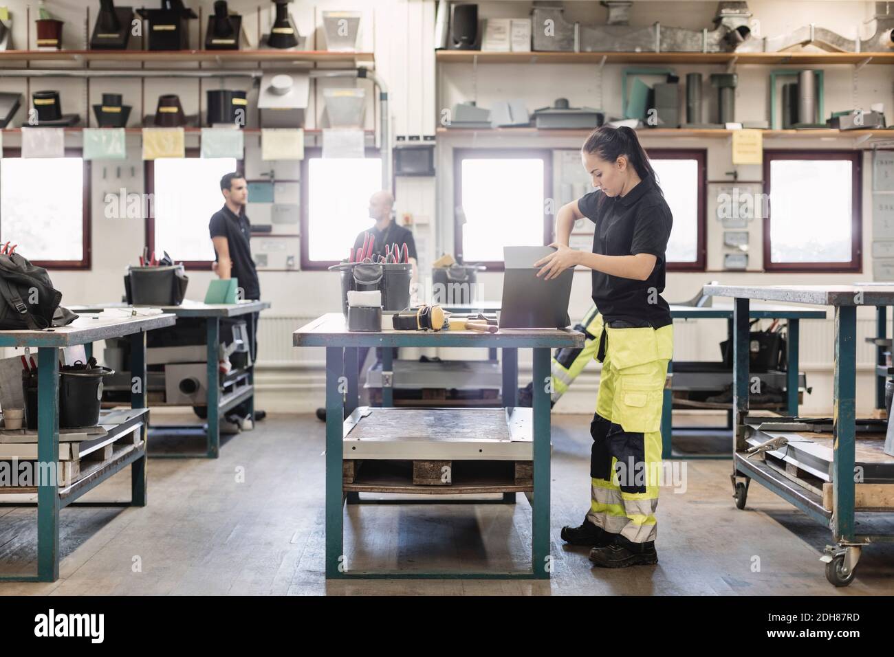 Side view of female high school student working on project in training ...