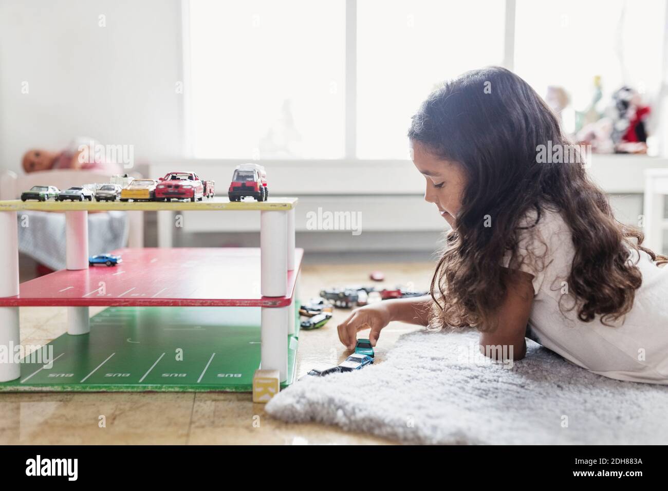 Preschool girl playing toy car hi-res stock photography and images - Alamy