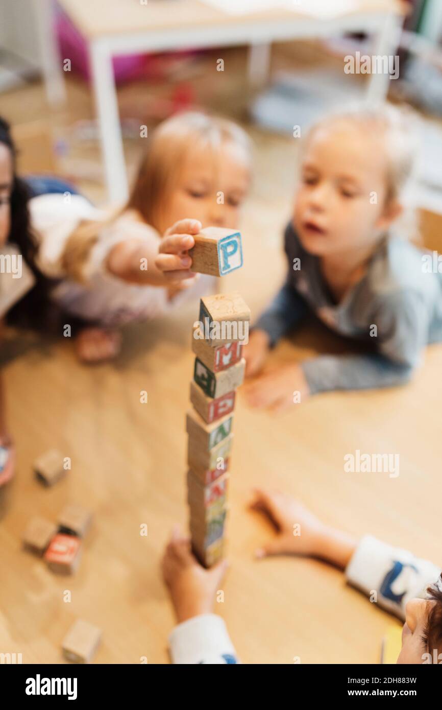 High angle view of children playing with blocks Stock Photo - Alamy
