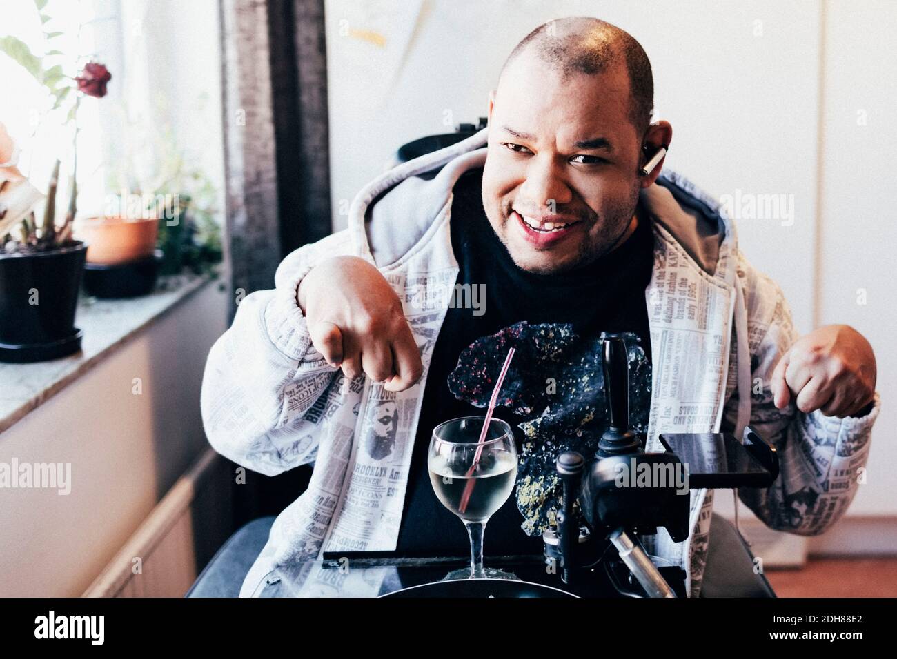 Portrait of happy disabled man with drink at recording studio Stock ...