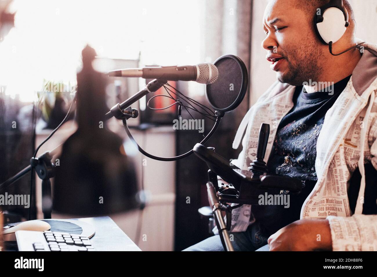 Disabled male singer recording music in studio Stock Photo - Alamy