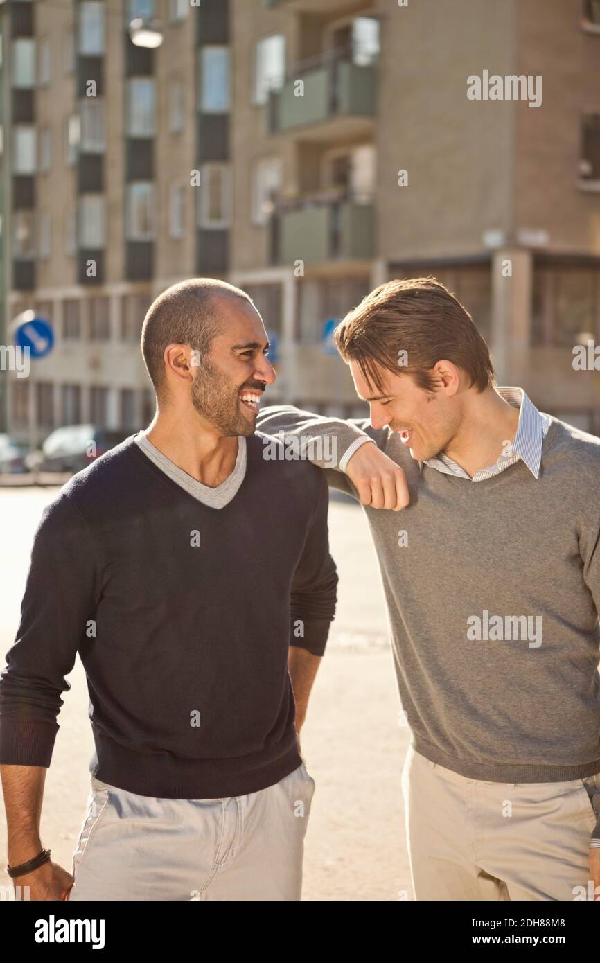 Front view of mid adult male friends enjoying together outdoors Stock ...