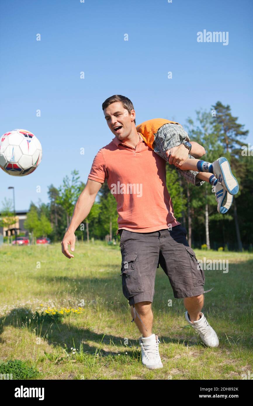 Two boys playing football in park hi-res stock photography and images ...