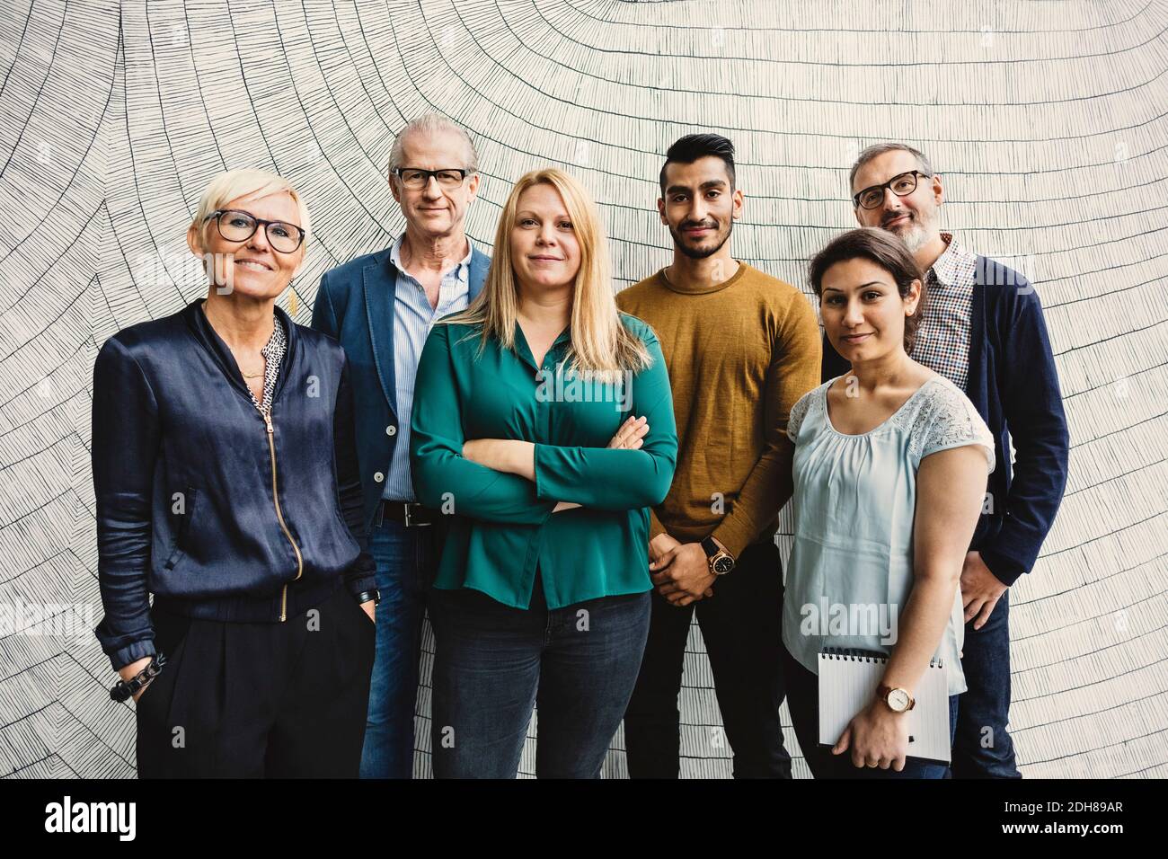 Group of people standing against wall hi-res stock photography and ...
