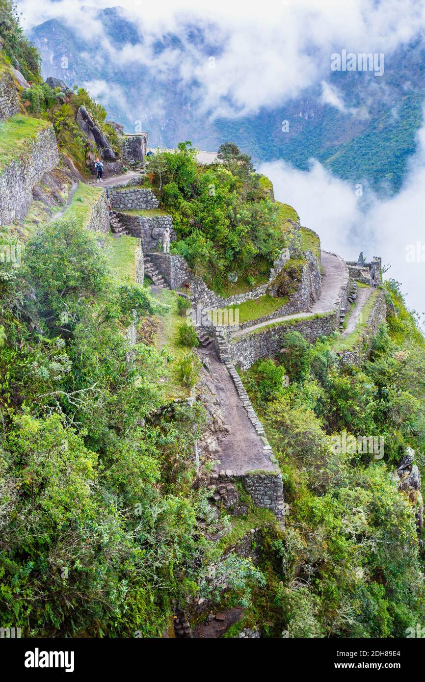 The stone staircase descent from Huayna Picchu and Inca terraces on ...