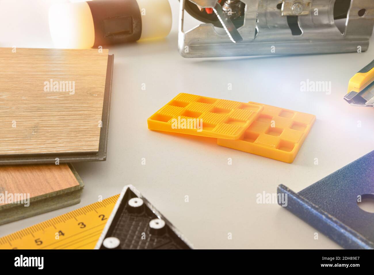 Detail of materials and tools on the white work table of a parquet ...