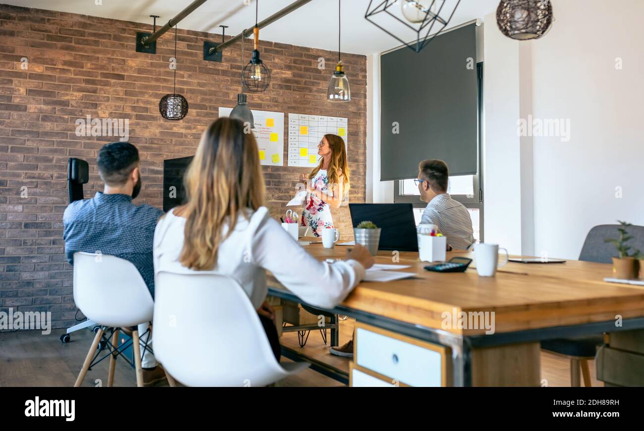Female manager explaining in a work meeting to her workers Stock Photo ...