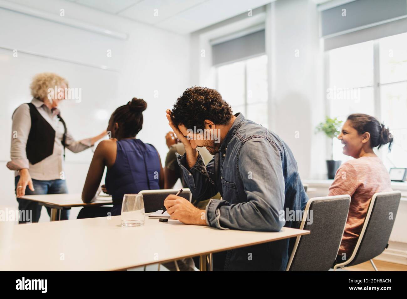 Students and teacher laughing at language class Stock Photo - Alamy