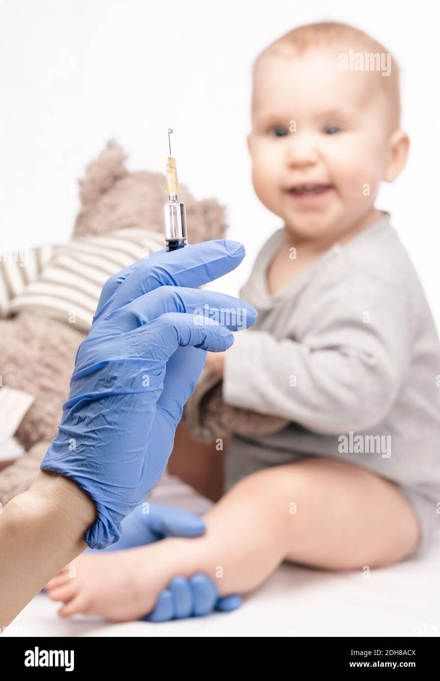 Pediatrician or nurse ready to give an intramuscular injection of a ...