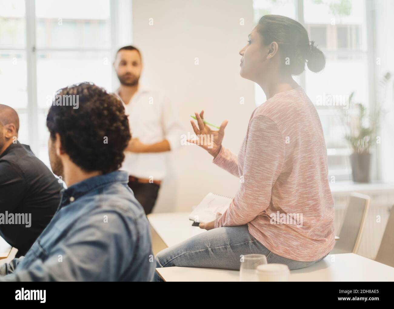 Confident student explaining while sitting in language class Stock ...