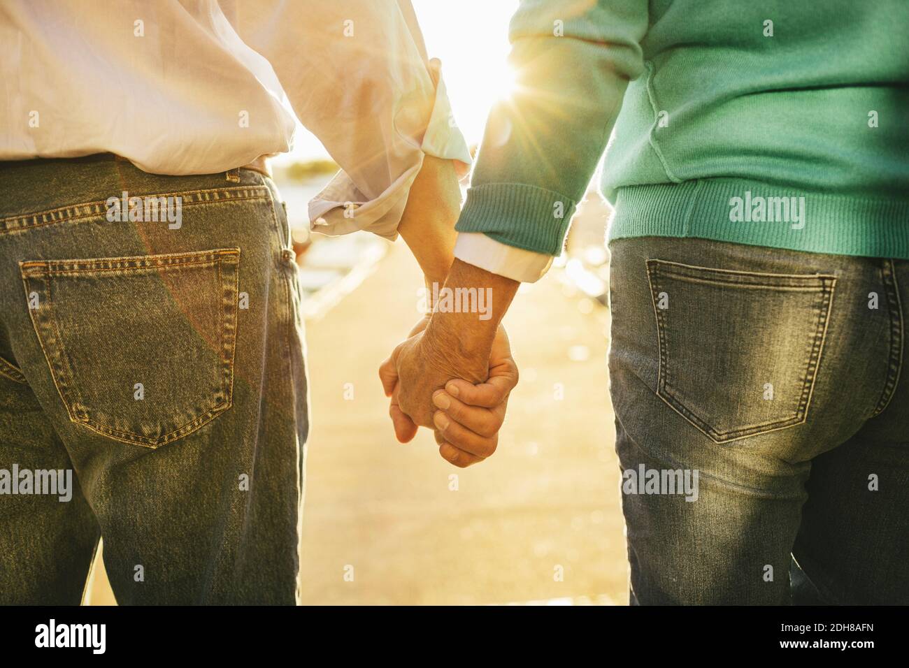 Two women holding hands back view hi-res stock photography and images ...