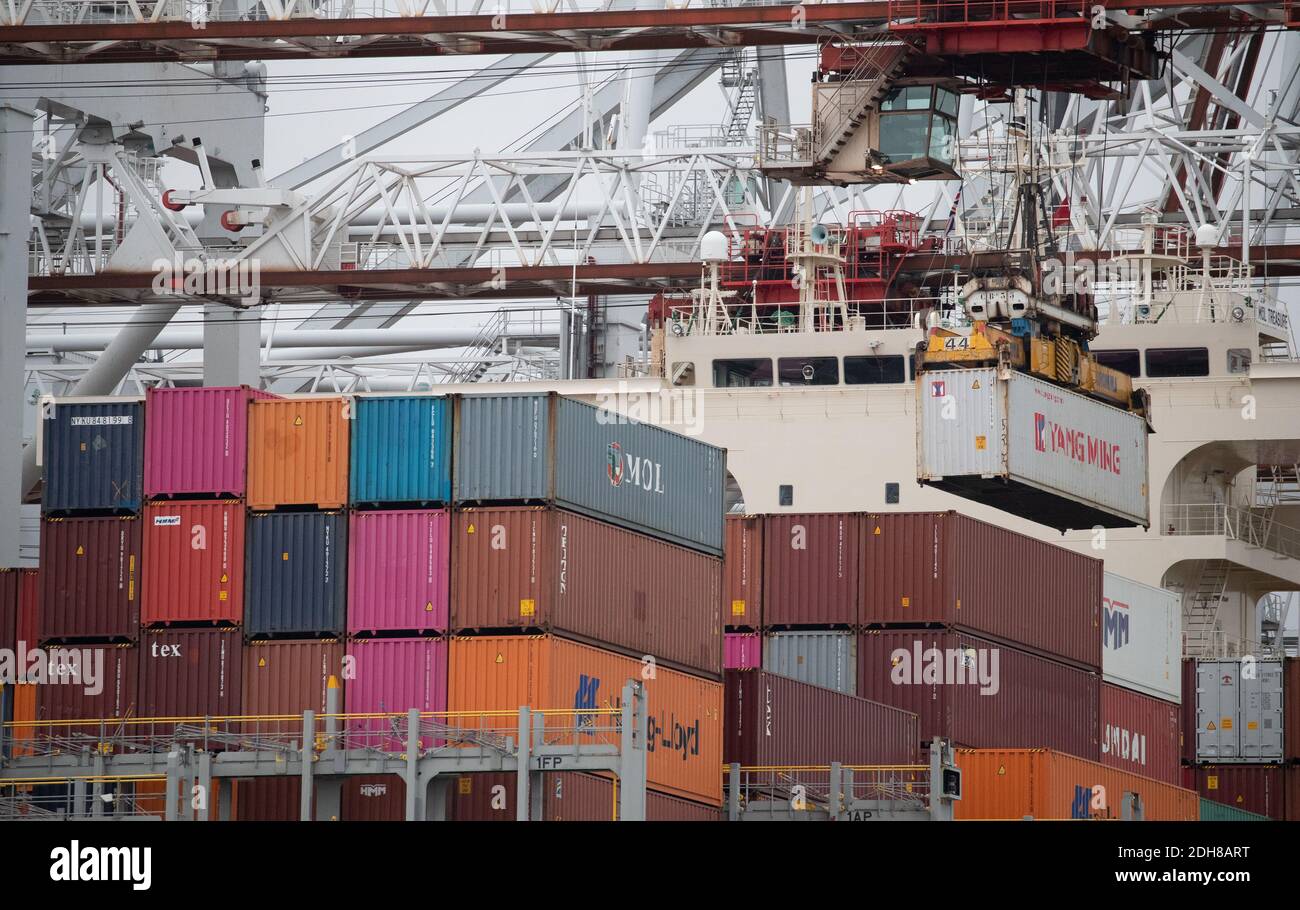 Containers are unloaded from the container ship MOL Treasure whilst at ...