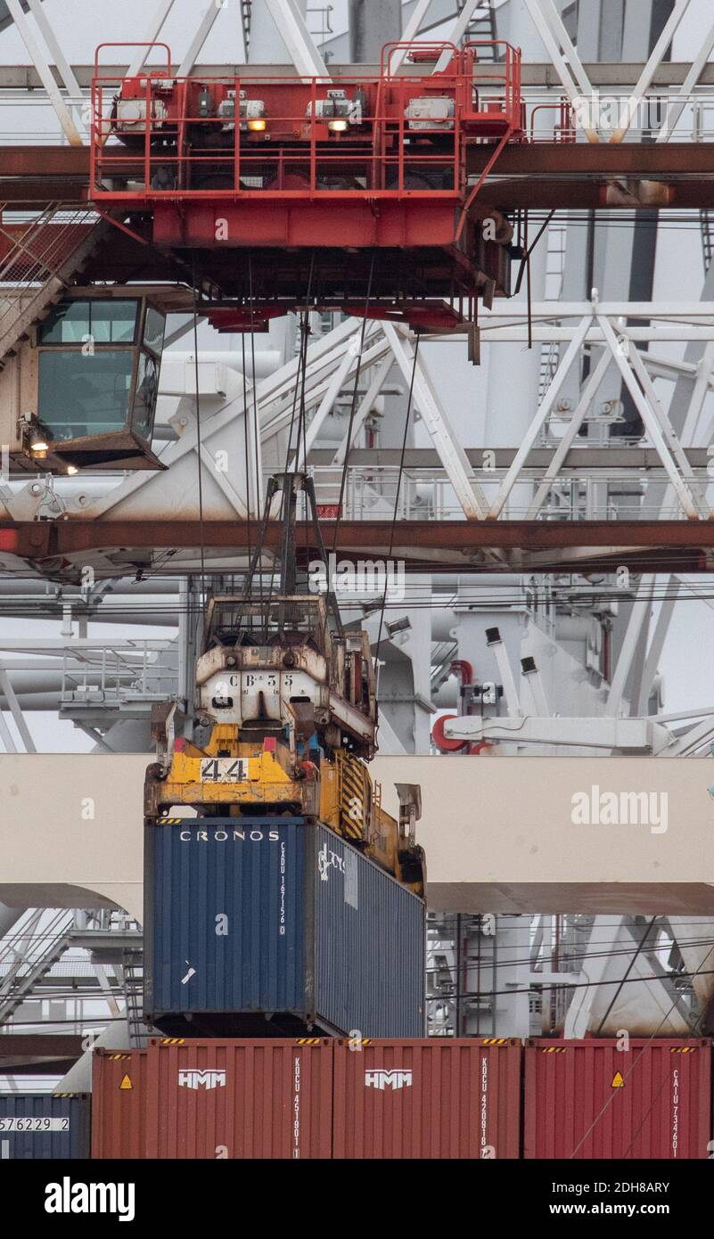 Containers are unloaded from the container ship MOL Treasure whilst at ...