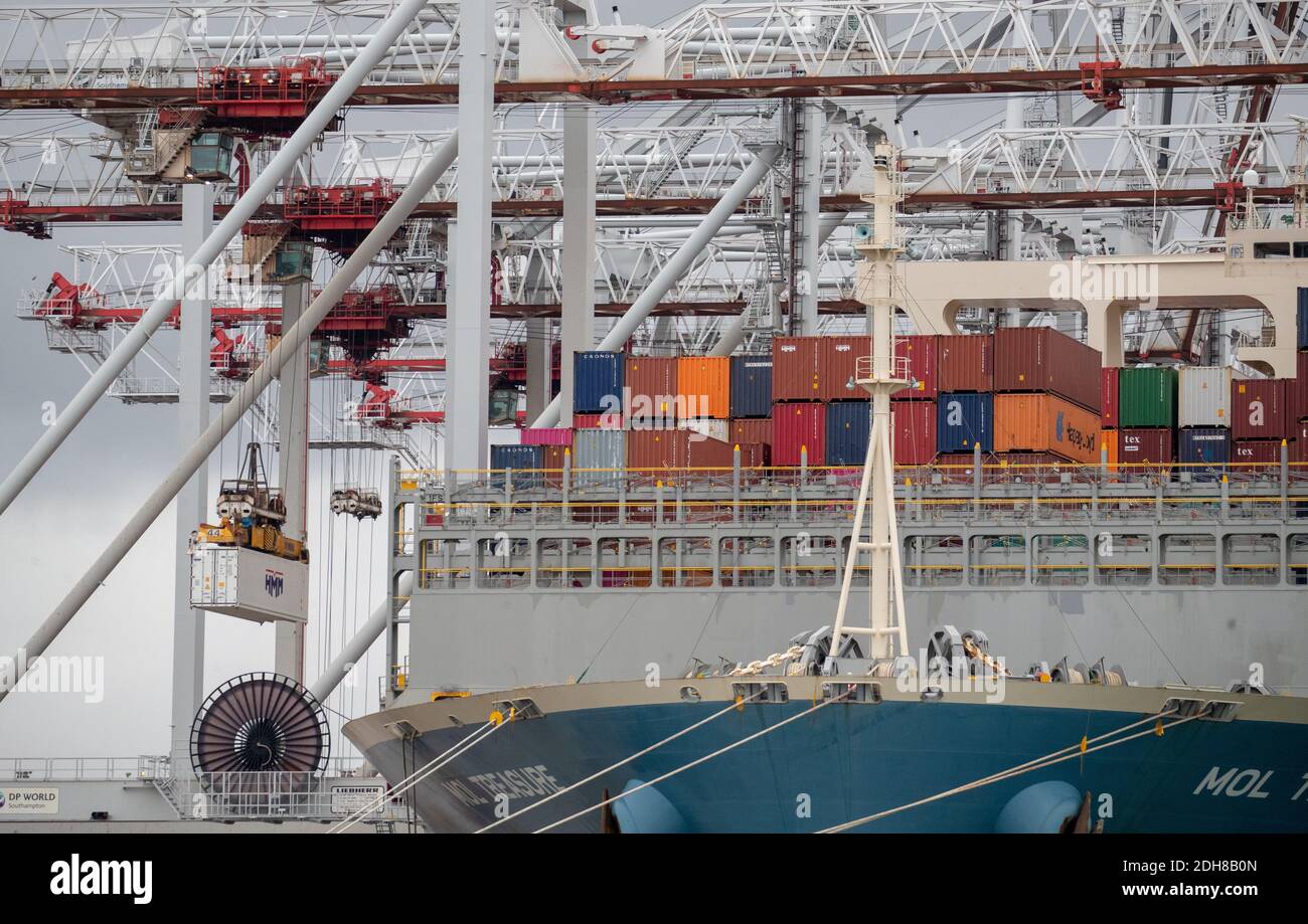 Containers are unloaded from the container ship MOL Treasure whilst at ...