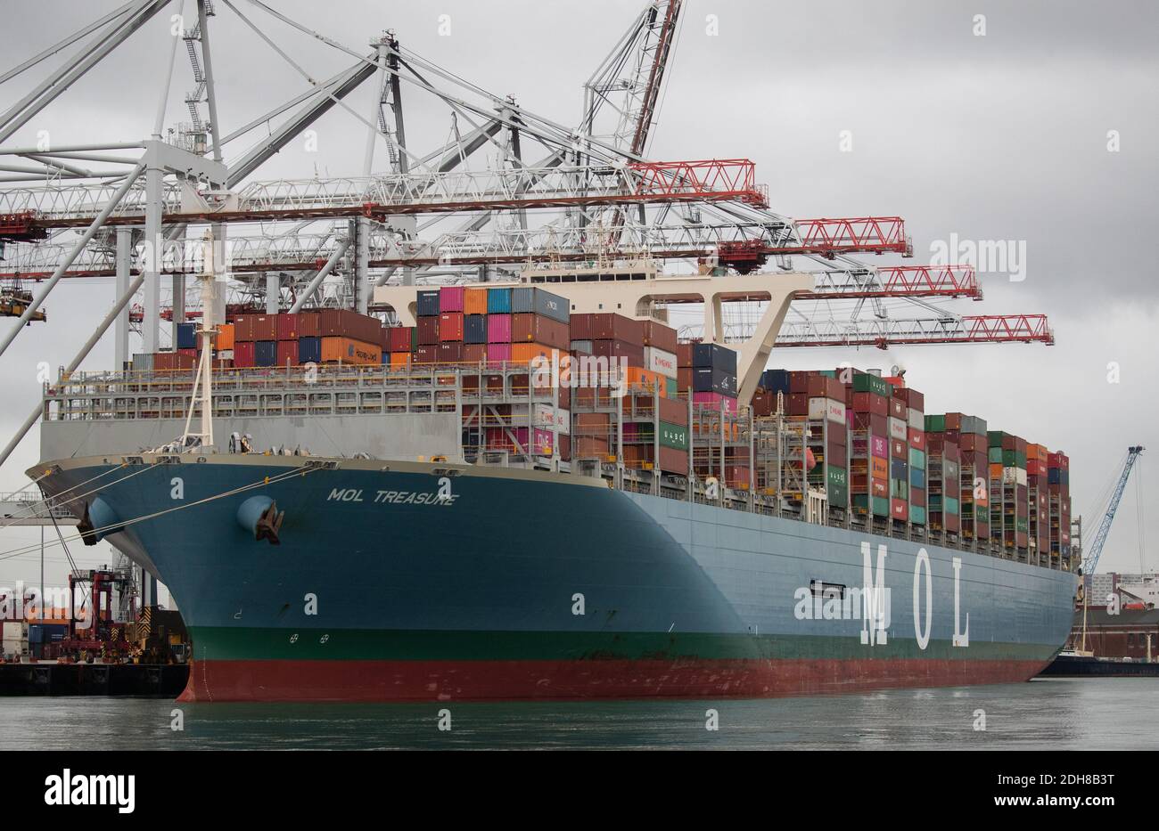 The container ship MOL Treasure has containers loaded and unloaded ...