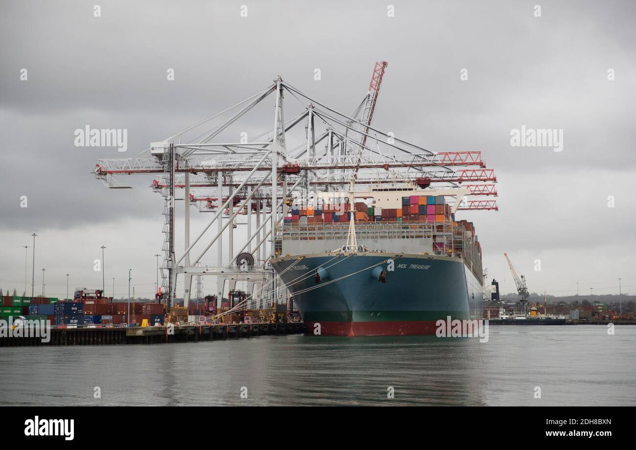 The container ship MOL Treasure has containers loaded and unloaded ...