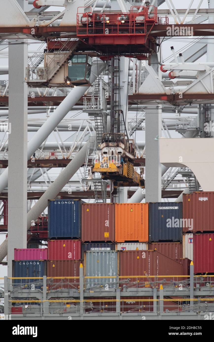 Containers are unloaded from the container ship MOL Treasure whilst at ...