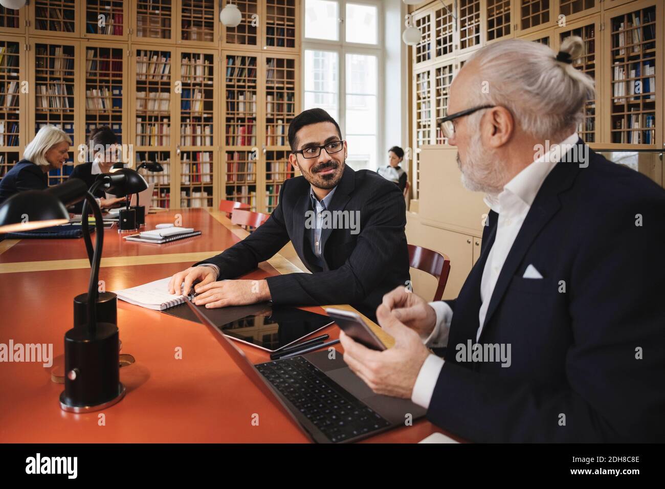 Smiling lawyer book table hi-res stock photography and images - Alamy