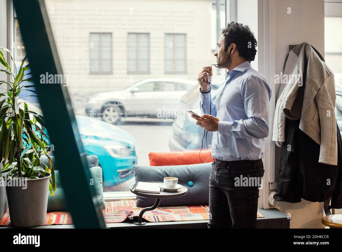Freelancer man standing window hi-res stock photography and images - Alamy