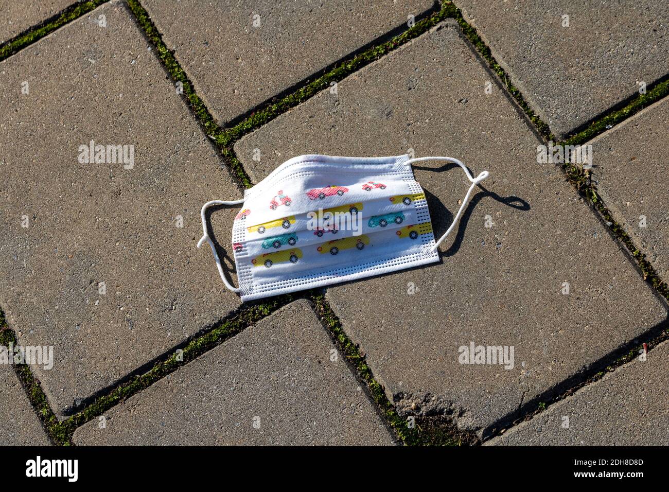 A closeup shot of dirty face mask on the ground Stock Photo - Alamy