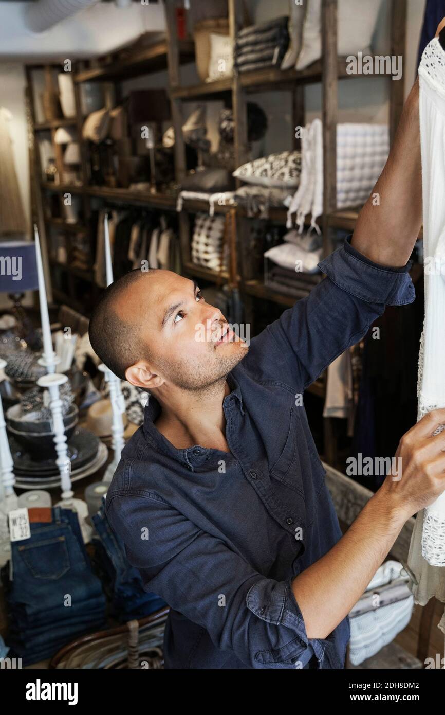 Male owner working in clothing store Stock Photo - Alamy
