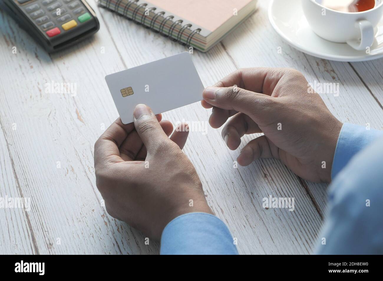 hand holding credit cards reading information Stock Photo - Alamy