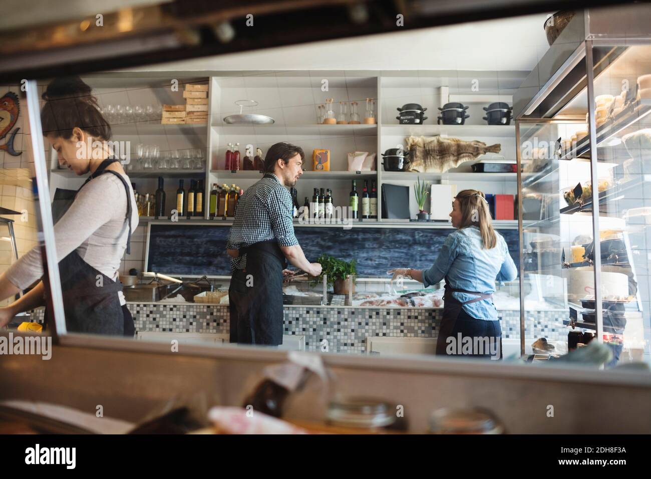 Male and female owners working in fish store Stock Photo - Alamy