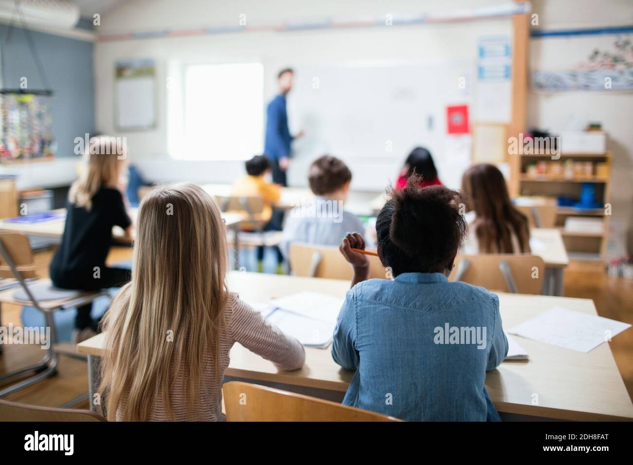 Rear view of students concentrating in classroom Stock Photo - Alamy