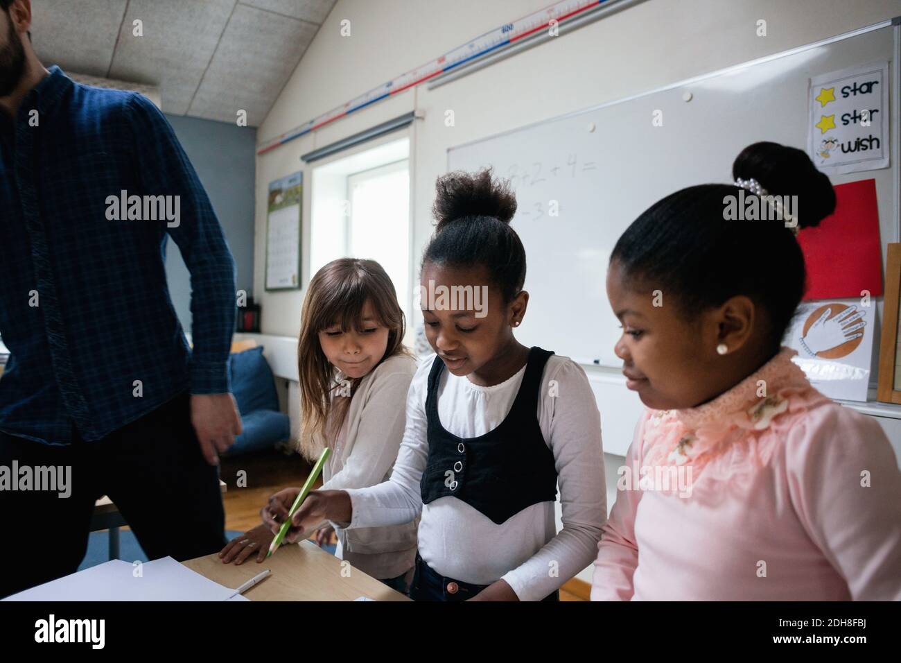 Teacher writing papers classroom hi-res stock photography and images ...