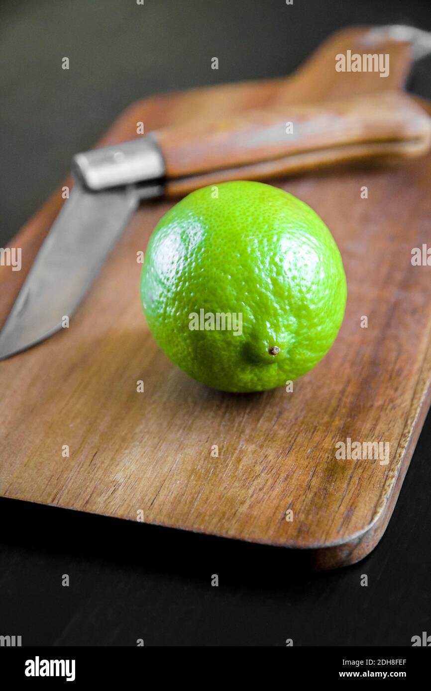 Lime and old traditional pocket knife on a cutting board Stock Photo ...