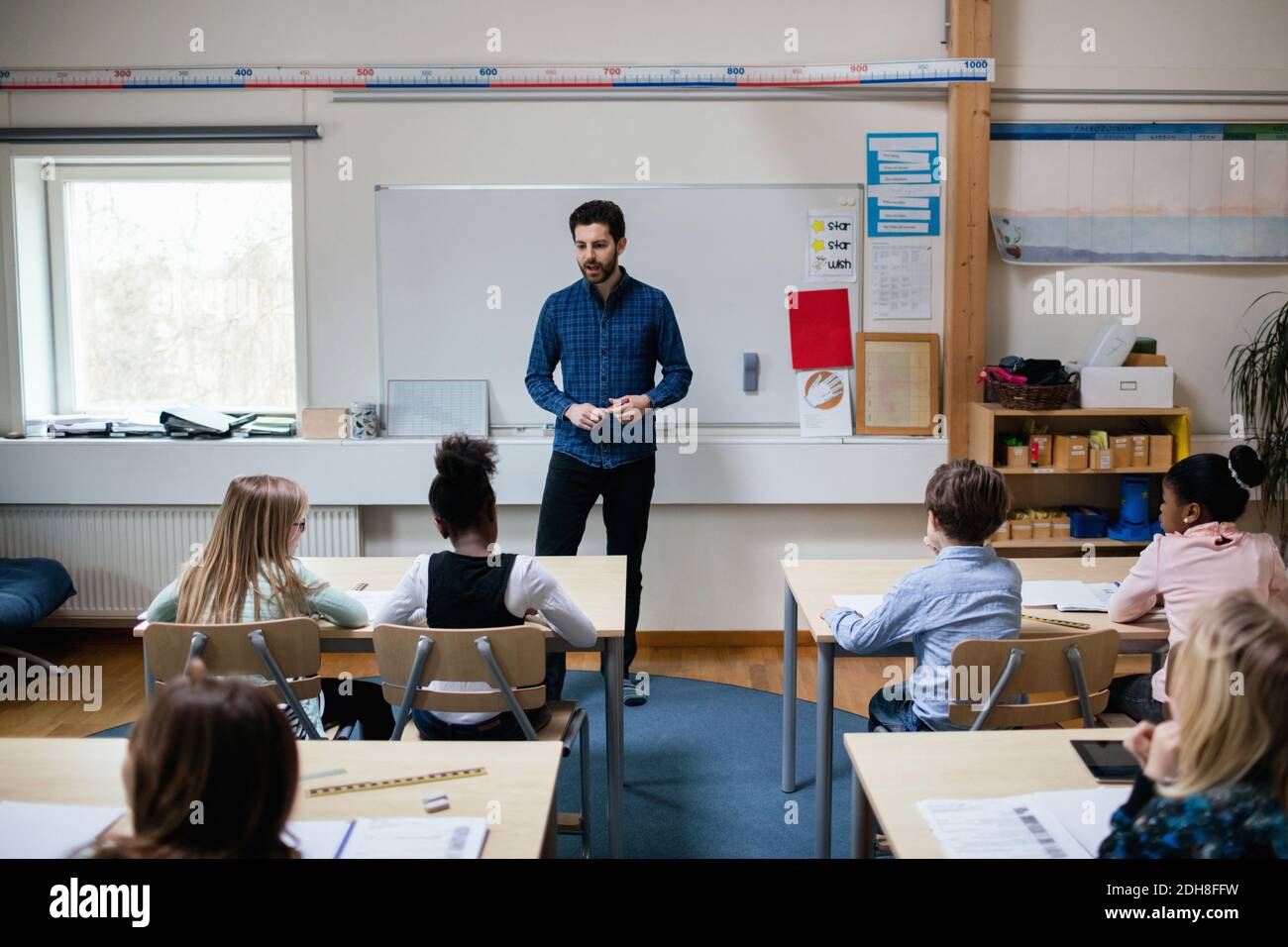Teacher sitting desk full view hi-res stock photography and images - Alamy