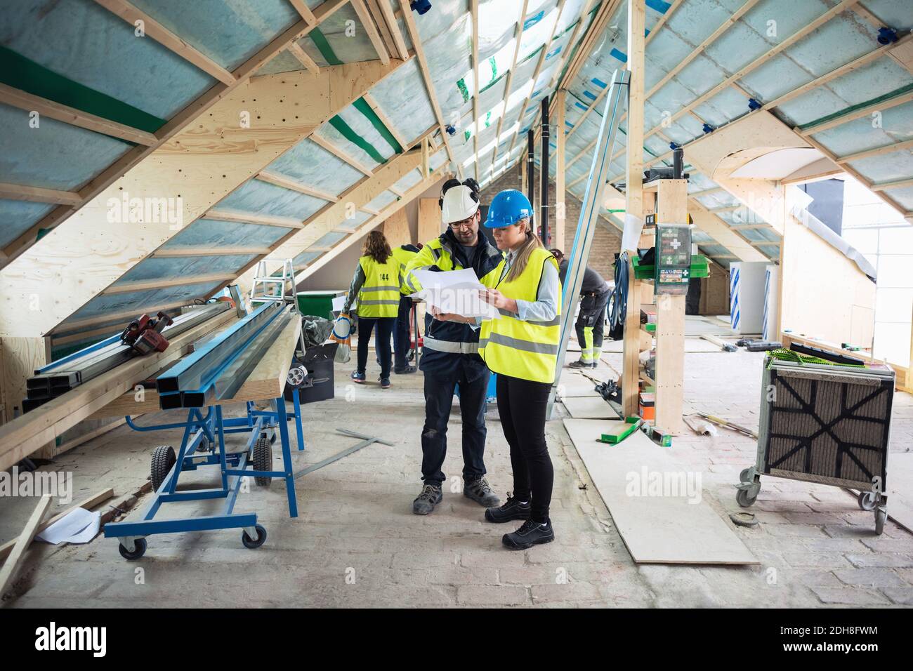 Construction managers planning while standing in messy site Stock Photo ...