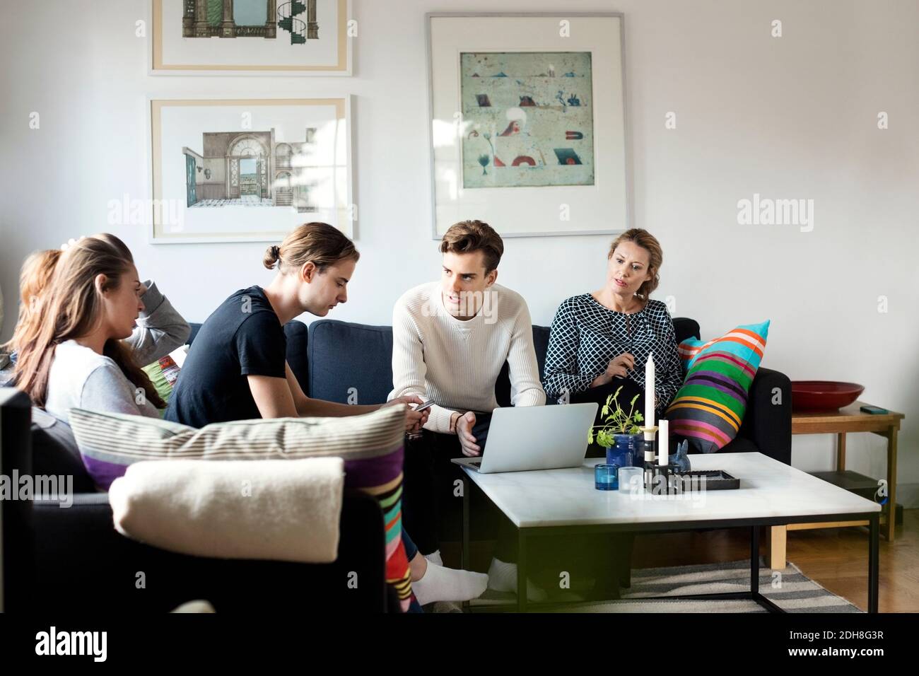 Family sitting in living room of new home Stock Photo - Alamy