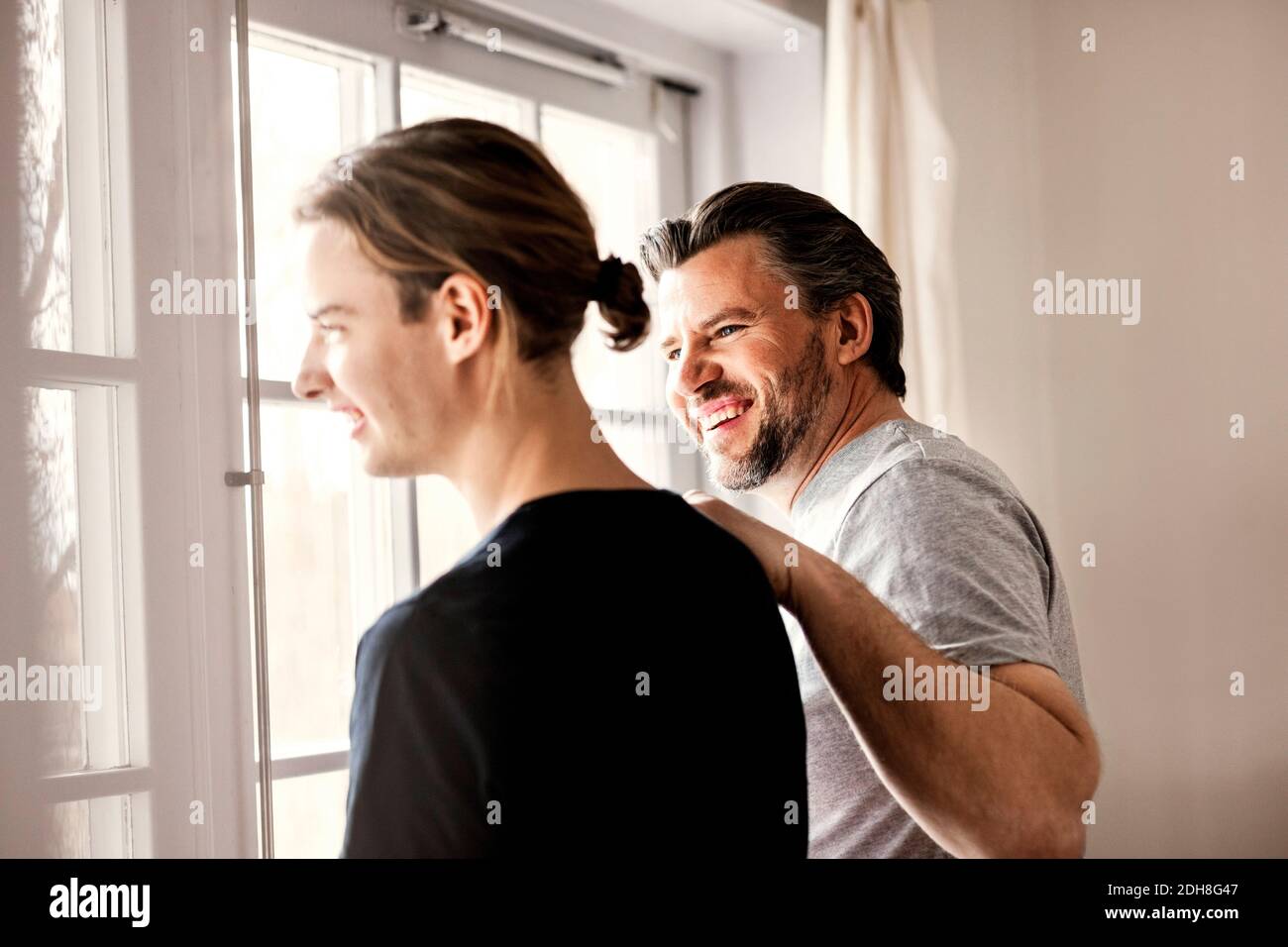 Happy father looking at son while standing by door at new home Stock ...