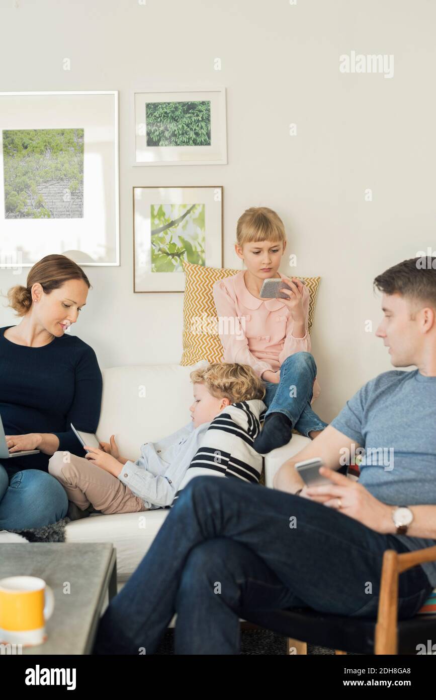 Family using technologies at home Stock Photo - Alamy